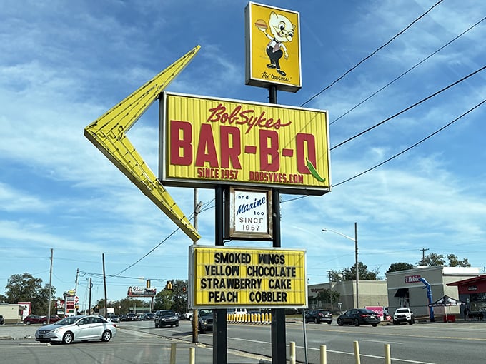 This sign doesn't just advertise a restaurant; it's a landmark that's guided generations of Alabamians to their happy place, one plume of hickory smoke at a time.