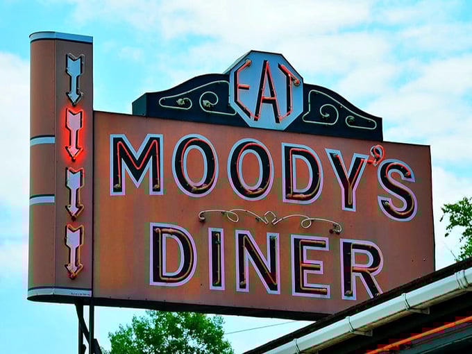That neon sign doesn't just advertise a diner&mdash;it announces an American institution where "EAT" is both command and promise.