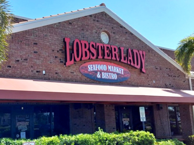 In daylight, the Lobster Lady sign promises what the night delivers: seafood excellence without pretension. Those palm trees aren't just landscaping&mdash;they're nature's way of saying "vacation vibes ahead."