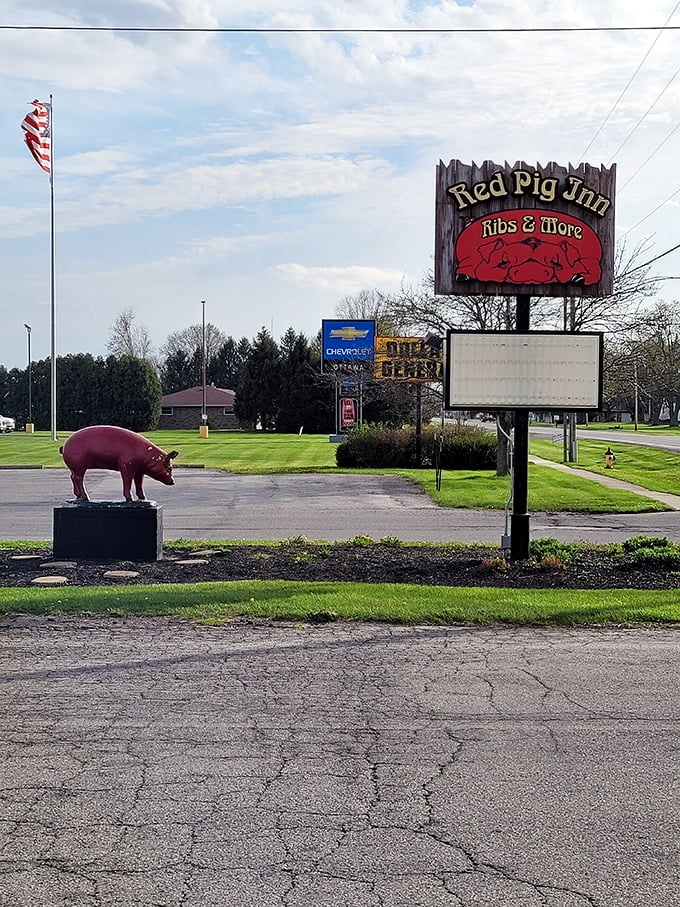 The iconic Red Pig sign and statue standing proud&mdash;like sentinels guarding the sacred smoke-infused treasures within.