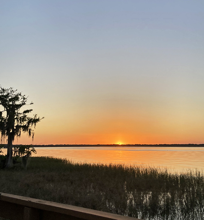 Lake Eustis at sunset transforms into a canvas of orange and gold &ndash; Mother Nature showing off her painting skills while you sip something cool.