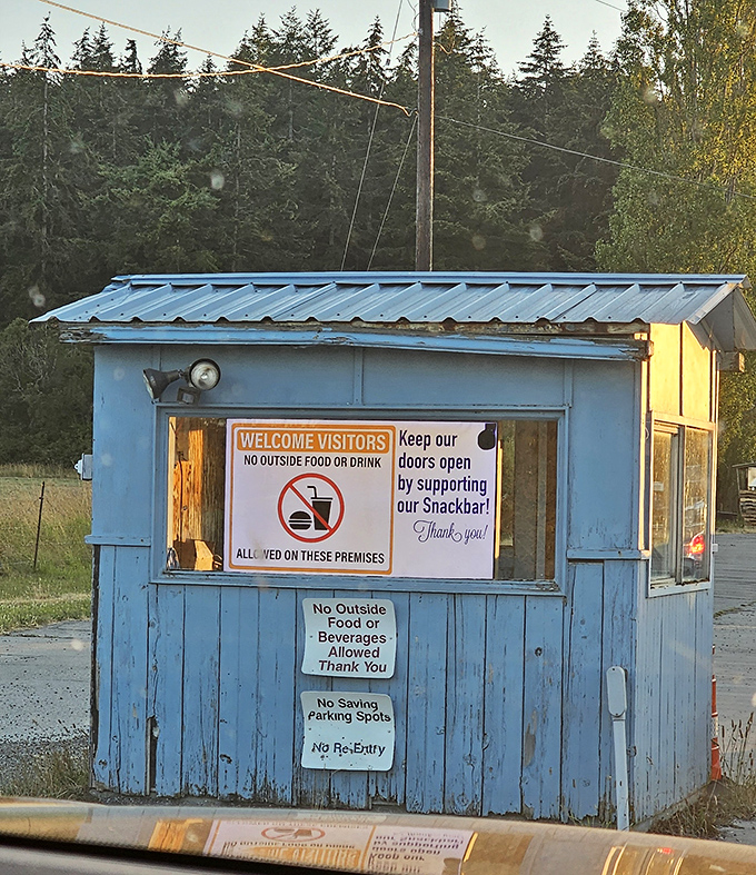 The ticket booth's friendly signs remind visitors that supporting the snackbar keeps this nostalgic treasure alive and thriving.