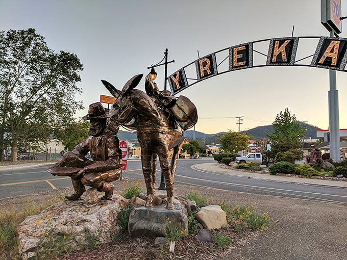 Yreka's welcome arch, supported by gold rush figures, greets visitors with a promise: here's where California dreams don't require California prices.