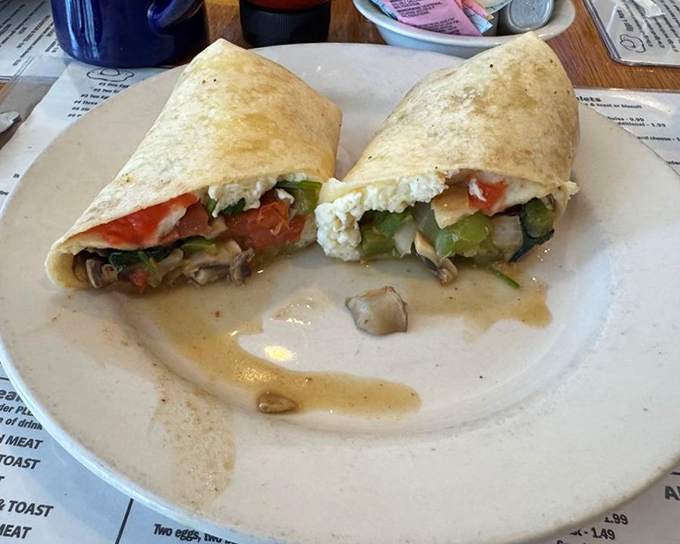 The veggie wrap&mdash;proof that healthy eating doesn't require sacrifice. A rainbow of vegetables nestled in a soft tortilla, with mushrooms adding earthy depth to every bite.