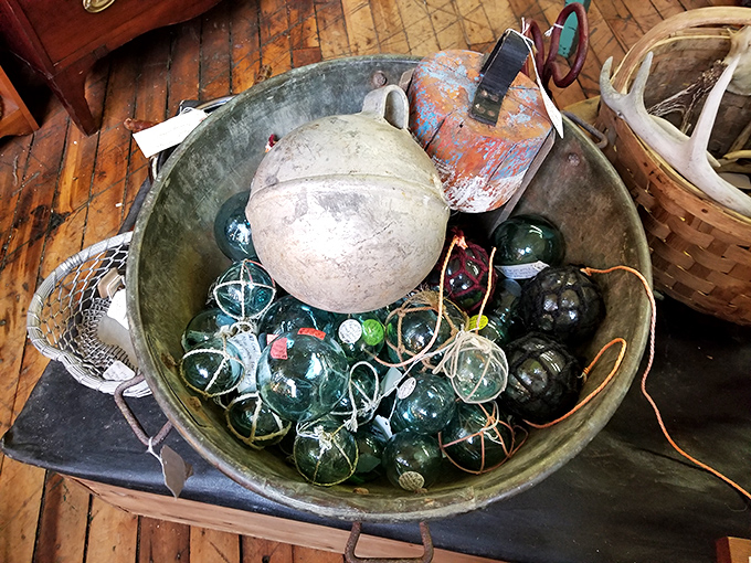 A basin of glass fishing floats&mdash;these sea-worn spheres once bobbed on distant waves before washing up as collectible pieces of maritime history.
