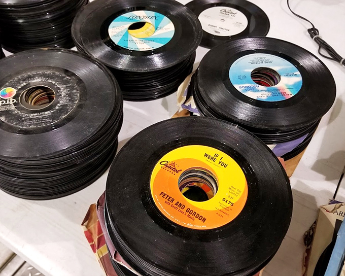 Vinyl treasures stacked like pancakes at a diner. Each 45 holds three minutes of someone's youth, waiting to spin memories once more.