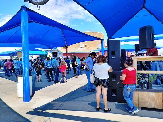 The market's social hub, where line dancing breaks out spontaneously and strangers become friends over shared discoveries of $5 vintage vinyl and hand-tooled leather belts.