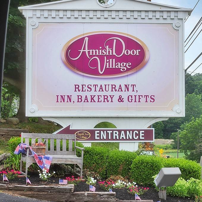 The Amish Door Village sign welcomes visitors to a destination where restaurant, inn, bakery, and gifts unite for maximum temptation.