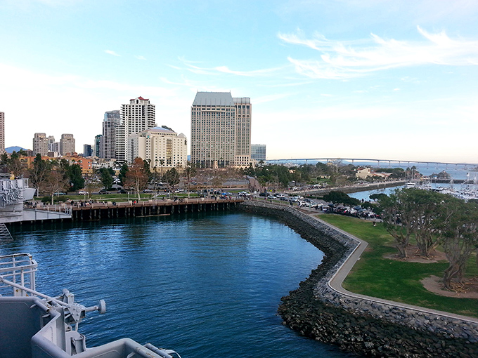 Late afternoon light falls upon the Coronado skyline, reflecting off the buildings as they overlook the deep blue bay and the shoreline park.