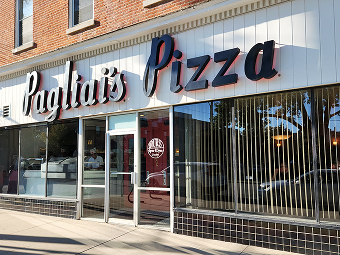The classic Pagliai's storefront beckons with its vintage sign. Behind that glass lies pizza paradise waiting to be discovered.