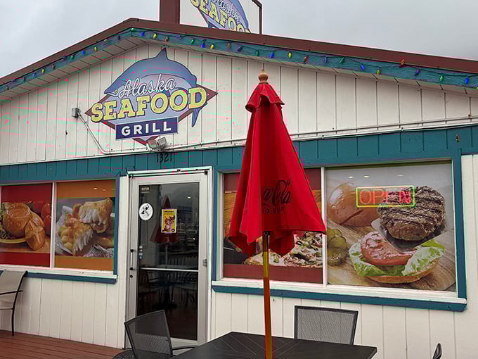 The Alaska Seafood Grill's cheerful exterior promises seafood treasures within. That blue trim and red umbrella? Pure coastal charm!