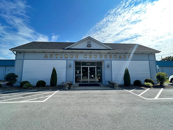 The welcoming exterior of Antique Crossroads in Hagerstown invites treasure hunters with its clean white fa&ccedil;ade and ample parking.