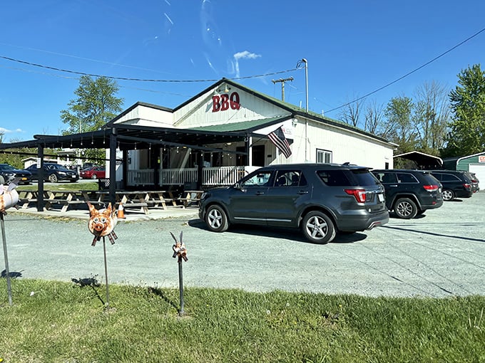 That classic white building with the welcoming porch? Pure barbecue magic waiting to happen inside.