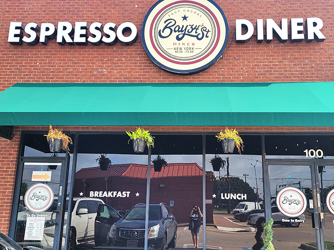 The brick facade of Bay34th Street Diner welcomes hungry Texans with its classic green awning and promise of espresso-fueled breakfast delights.