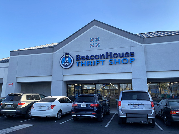 The bright blue Beacon House sign beckons like a lighthouse for bargain hunters navigating the sea of retail.