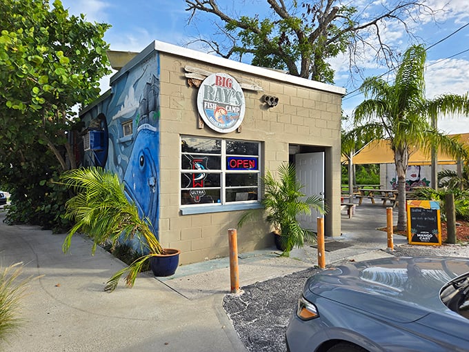 Big Ray's Fish Camp exterior showcases a charming blue fish mural. This tiny Tampa treasure proves the best seafood often comes in small packages!