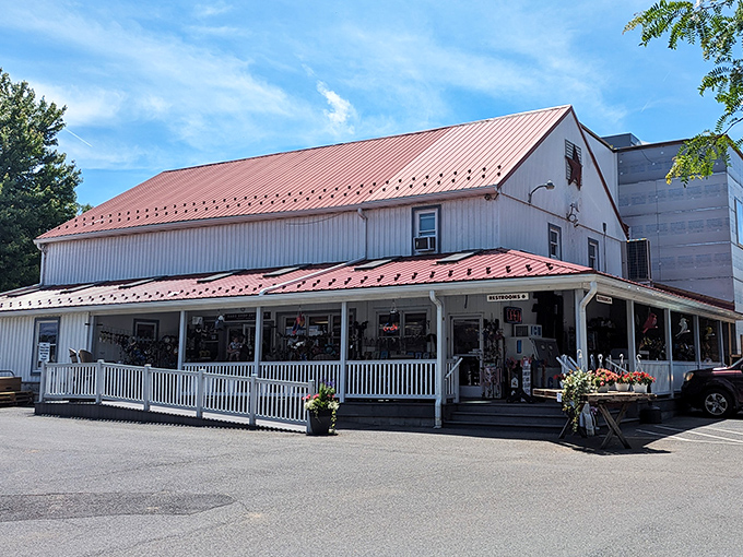 The classic white building with red roof at Bird-in-Hand Bake Shop stands like a temple to butter and sugar.