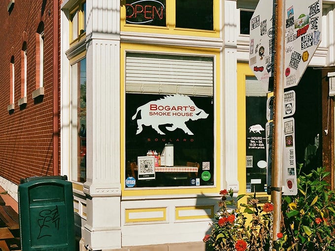 The iconic pig silhouette at Bogart's Smokehouse promises smoky treasures behind that yellow-trimmed storefront.