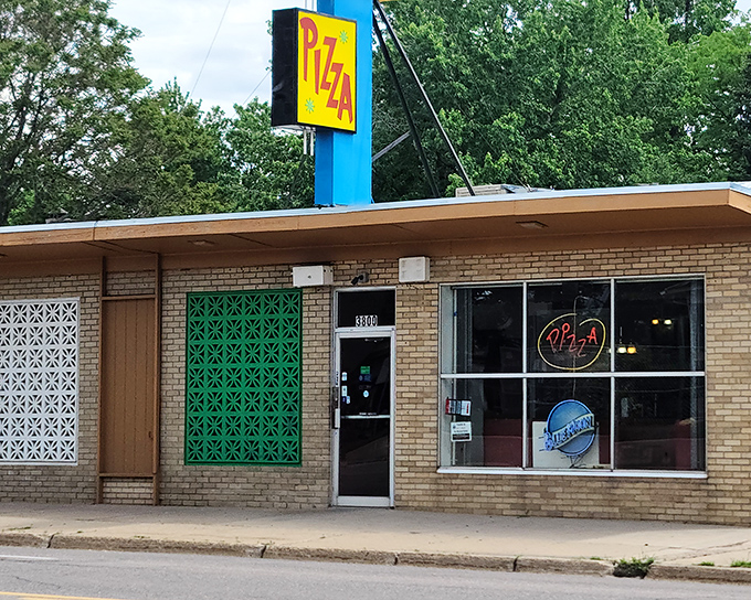 That vintage yellow "PIZZA" sign has been calling hungry Denverites home for decades like a neon North Star.