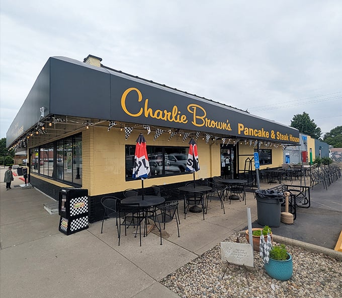 Racing flags and outdoor seating signal serious breakfast business - Charlie Browns knows comfort starts before you walk in.