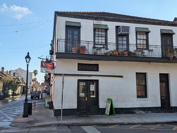 The historic Clover Grill stands proudly on Bourbon Street, its vintage Coca-Cola sign beckoning hungry travelers like a neon lighthouse in the French Quarter.