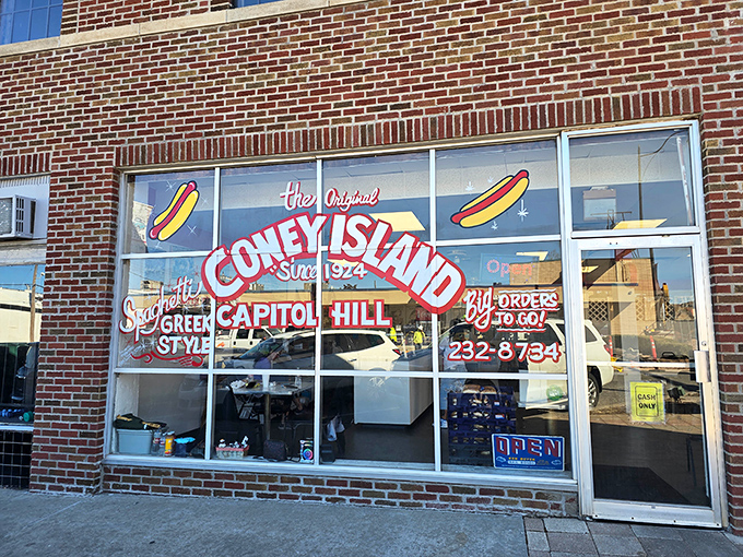 The Original Coney Island storefront beckons with its vintage charm. That red and white sign promises Greek-style hot dog heaven!