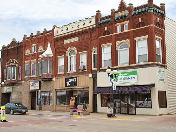 Classic red brick storefronts stand like proud sentinels, watching over a Main Street where parking meters still accept quarters.