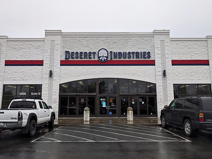 The white facade of Deseret Industries beckons like a treasure cave with automatic doors. Bargain hunters, your paradise awaits!