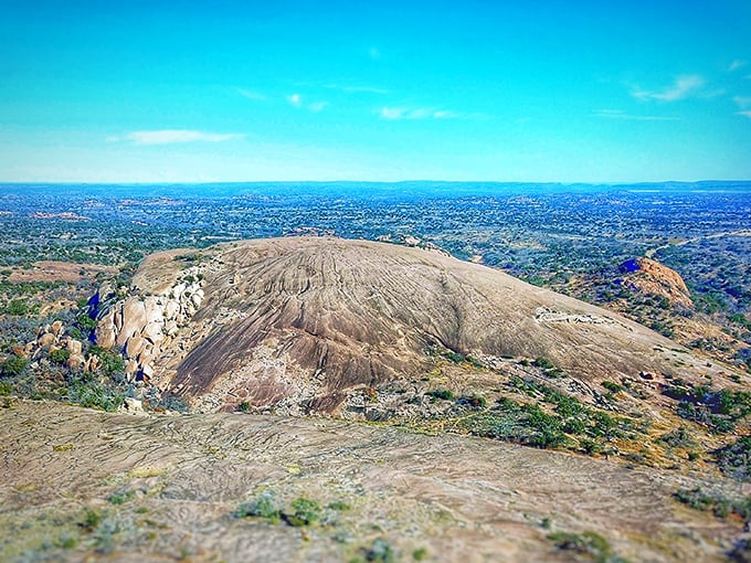 The massive pink granite dome of Enchanted Rock rises from the Texas landscape like nature's own monument to geological wonder.