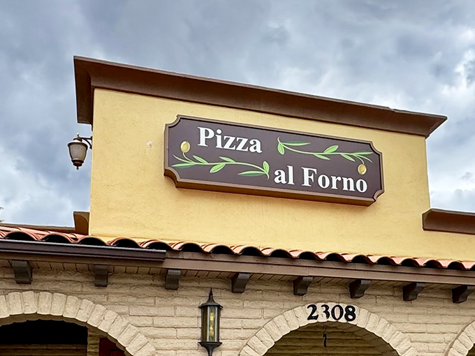 The golden glow of Fat Olives' exterior promises wood-fired delights within. That sign might as well say "Pizza Paradise Ahead!"