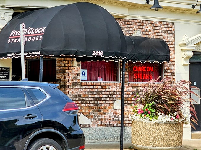 The black awning and brick facade whisper "serious steak business happens here." No frills, just thrills for your taste buds.