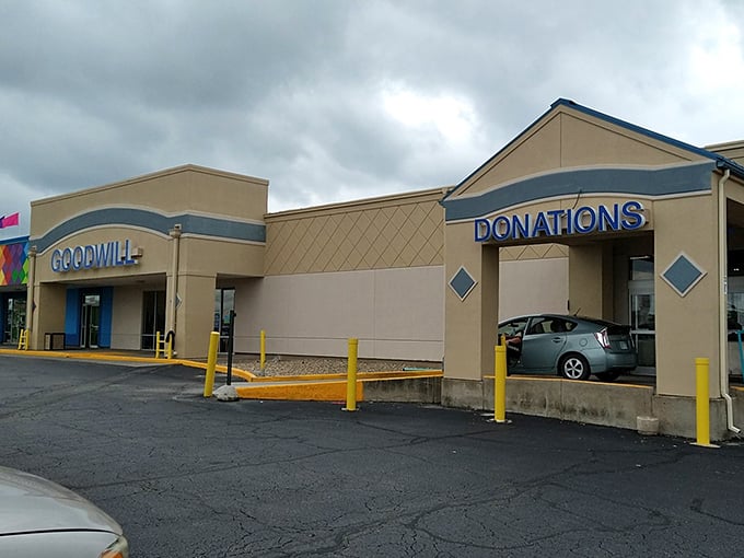 Treasure hunting begins! Goodwill Topeka's tan fortress beckons with promises of hidden gems while clouds gather overhead like bargain-hungry shoppers.