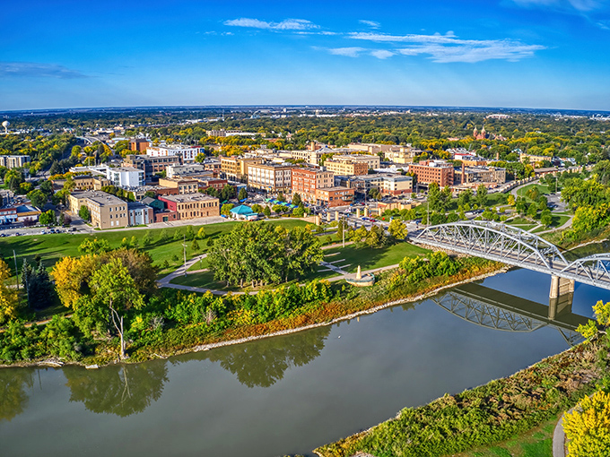 Grand Forks from above – where the Red River curves like nature's signature on a postcard perfect landscape.