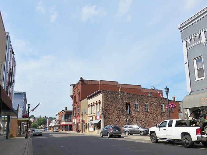Historic brick storefronts line Ishpeming's main street, where buildings tell stories without saying a word about simpler times.