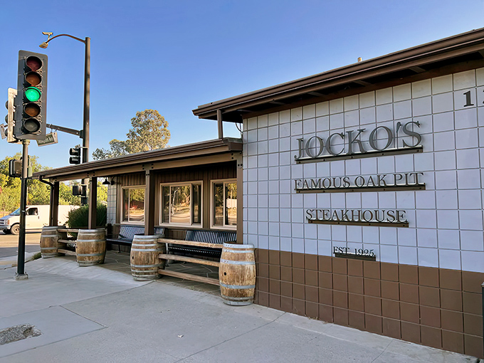 Jocko's exterior welcomes hungry travelers with rustic charm. Those wooden barrels aren't just for show &ndash; they're saving your spot for steak paradise!
