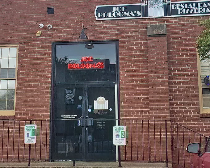 Joe Bologna's iconic brick exterior with glowing neon sign promises Italian comfort in a historic Lexington building.