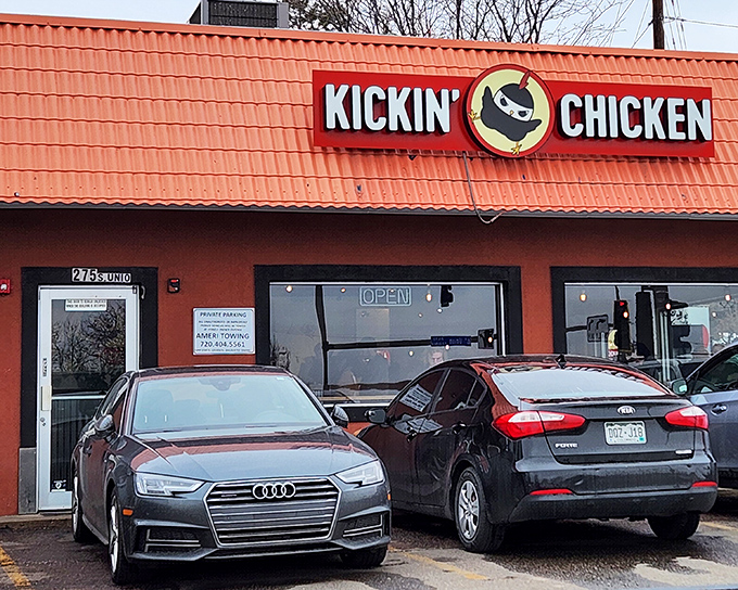The bright orange roof of Kickin' Chicken stands out like a superhero cape for fried chicken lovers. No fancy frills, just serious flavor inside.