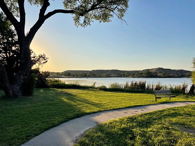 Sunset serenity at Lake Scott State Park. That bench is practically begging you to sit and watch nature's evening show unfold.