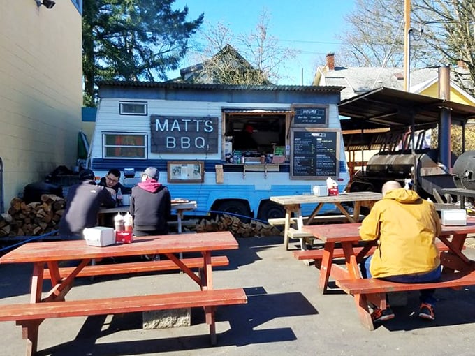 The little blue BBQ cart that could! Picnic tables fill with happy eaters drawn by the siren call of perfect Texas-style brisket.