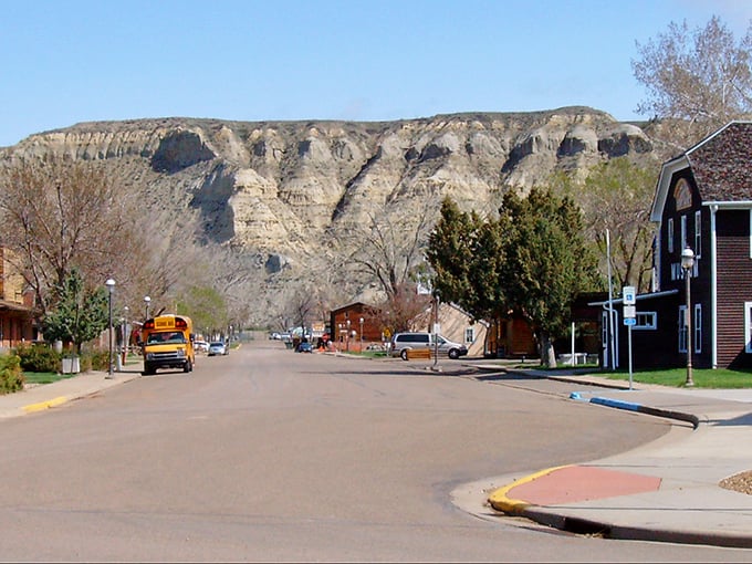 Main Street Medora stretches toward badlands bluffs like a Western movie set waiting for action.