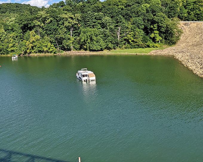 A peaceful houseboat drifts on Mohican's emerald waters. Nature's version of a five-star hotel with unlimited room service!