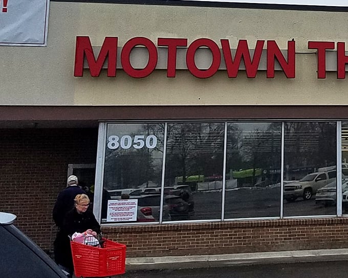 The iconic red Motown Thrift sign beckons bargain hunters like a retail lighthouse. Shopping carts await your treasure-hunting expedition!