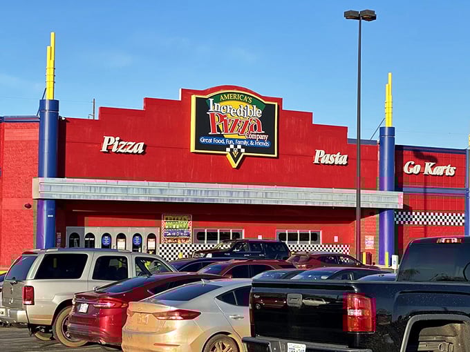 The bright red exterior of Incredible Pizza Company promises more than just arcade fun. Pizza paradise awaits inside this family entertainment wonderland.