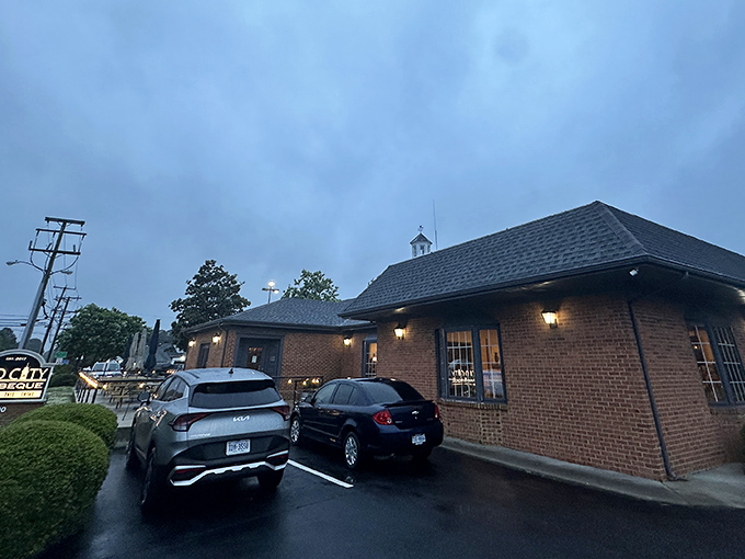 Evening lights cast a warm glow over this brick barbecue haven where smoky dreams come true.