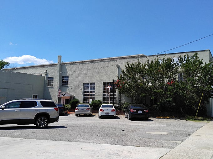 The unassuming exterior of Old Mill Antique Mall hides a treasure trove within, like finding out your quiet neighbor collects vintage motorcycles.