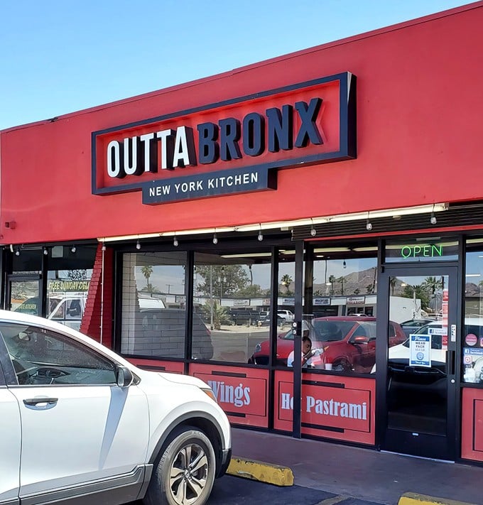 The bright red storefront of Outta Bronx promises New York deli magic in the heart of Phoenix. A taste of the Big Apple awaits!
