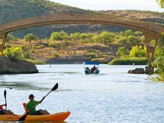 That curved bridge and sparkling water create a scene straight from a travel magazine cover.