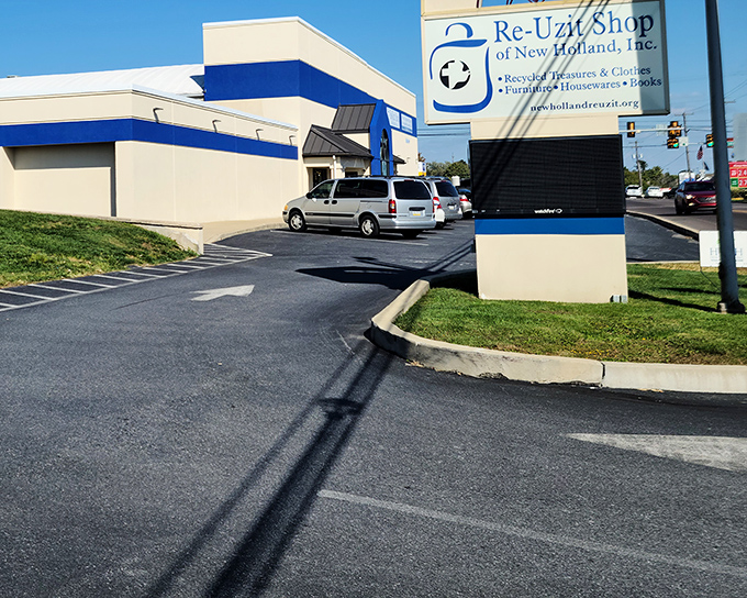 The blue and white exterior of Re-Uzit Shop stands like a treasure chest waiting to be opened. Bargain hunters, prepare for adventure!