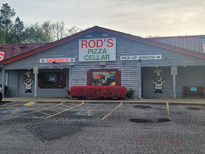 The weathered wood exterior and classic signage of Rod's Pizza Cellar feels like stepping into a time machine. Pizza paradise awaits inside!