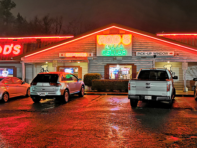 Rod's Pizza Cellar glows like a beacon in the night, promising cheesy salvation to weary travelers with its neon-lit charm.